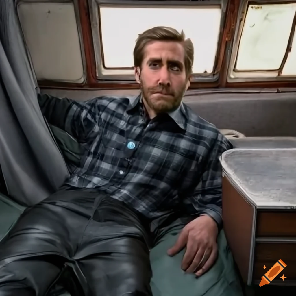 Actor resembling Jake Gyllenhaal sitting in a vintage caravan trailer ...
