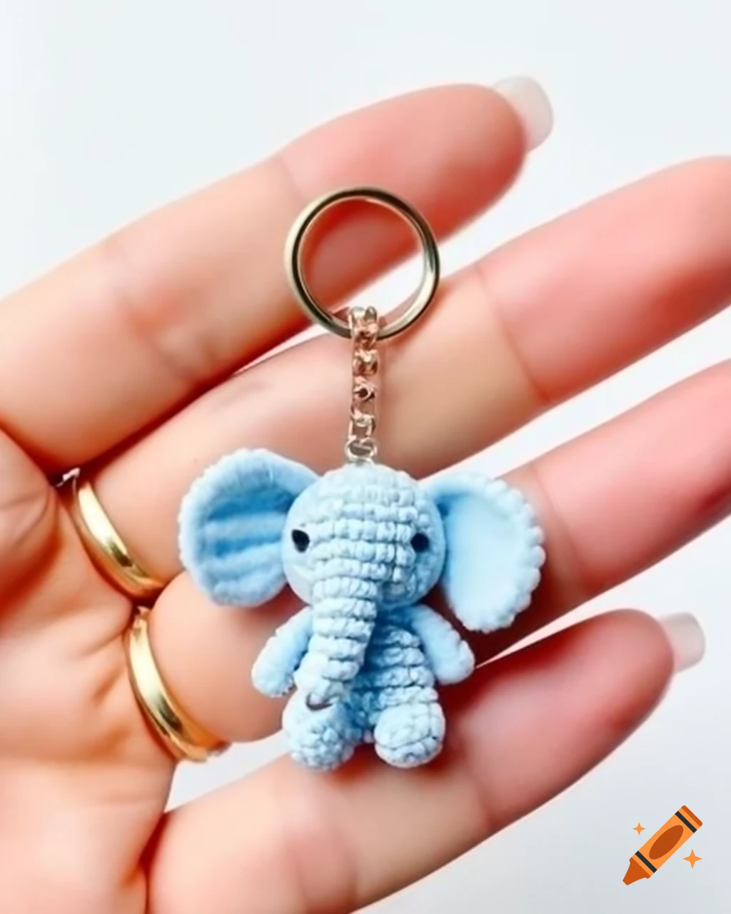 Crocheted elephant keychain held in hand on Craiyon