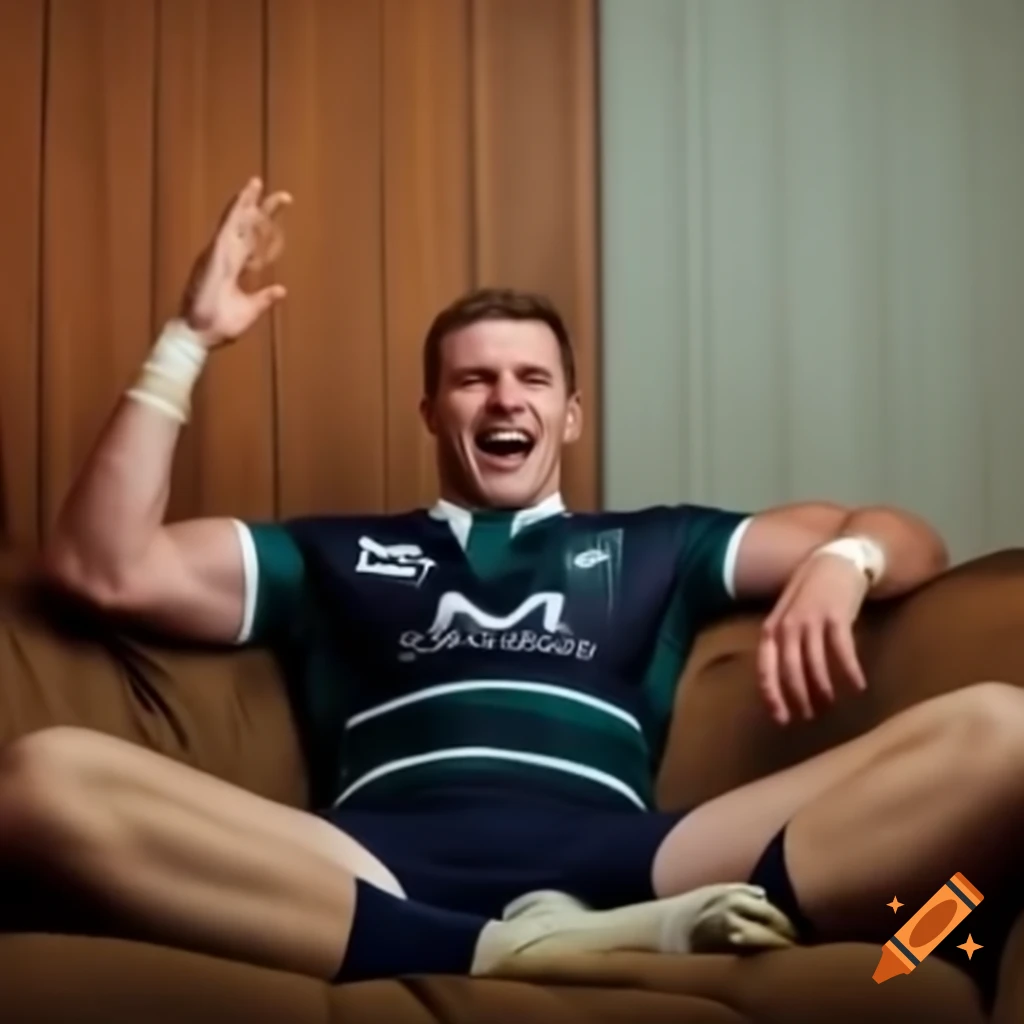 Rugby player Joe Marler relaxing on couch in uniform with playful smile ...